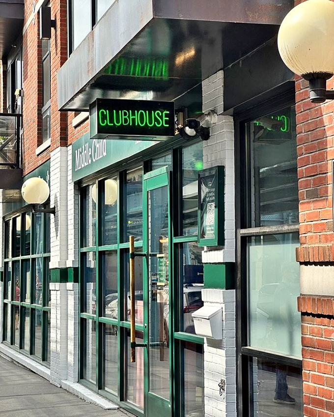 The glowing green "CLUBHOUSE" sign serves as a beacon for sandwich seekers, like the Bat-Signal but for the deliciously hungry.