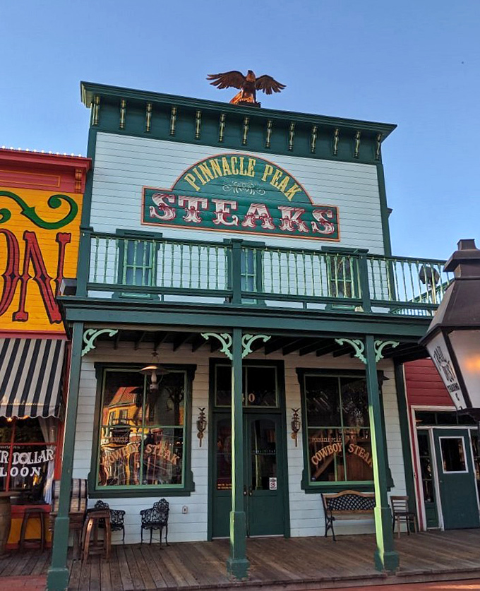 As the sun sets, Pinnacle Peak's iconic facade glows with promise. That eagle on top isn't just decoration&mdash;it's guarding the steaks.