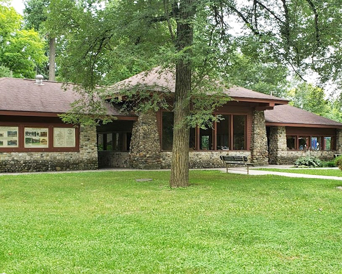 The park's main building nestles among mature trees, its stone facade and green lawns creating that quintessential Midwestern oasis that practically screams "community picnic here!"