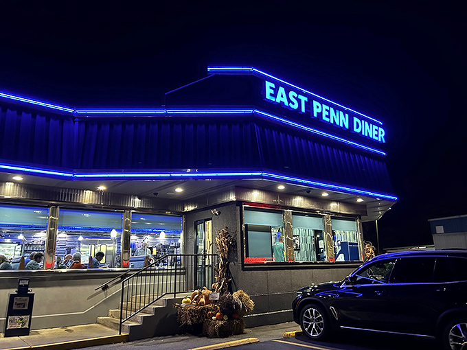 As evening falls, the East Penn Diner transforms into a blue-lit beacon of hope for hungry travelers and locals alike. Comfort food never looked so inviting.