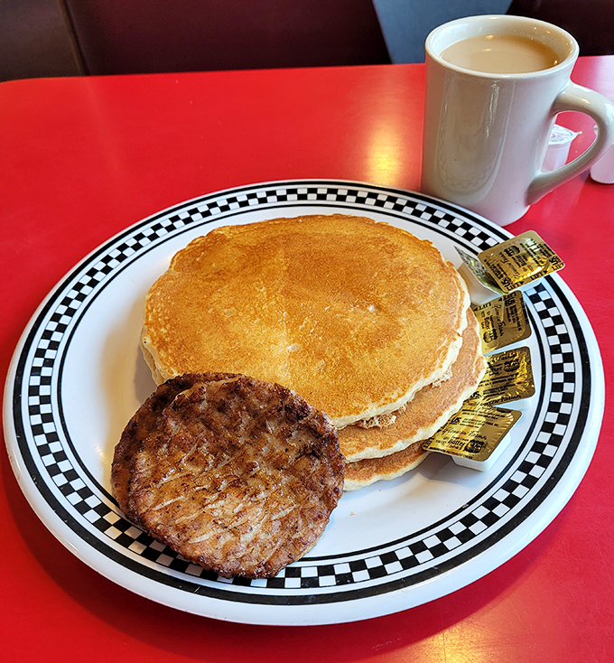 Pancakes so fluffy they practically hover above the plate, with sausage standing guard to ensure you don't float away on a maple syrup cloud.