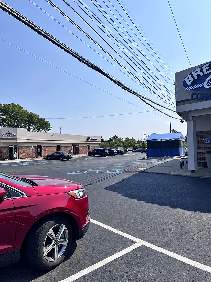 Even the parking lot feels welcoming, with the blue awning hinting at the breakfast paradise that awaits just steps away.