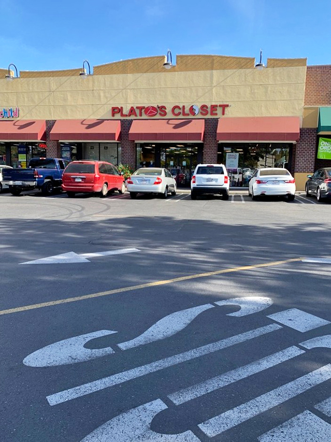 The storefront stands proudly between its retail neighbors, a temple of textile recycling where fashion gets its second chance at greatness.