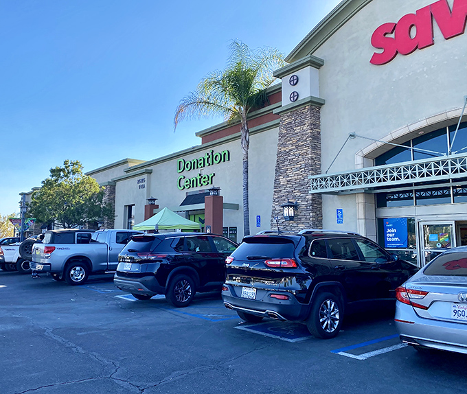 The parking lot view reveals both the shopping and donation entrances&mdash;the alpha and omega of the thrifting lifecycle under perfect California skies.
