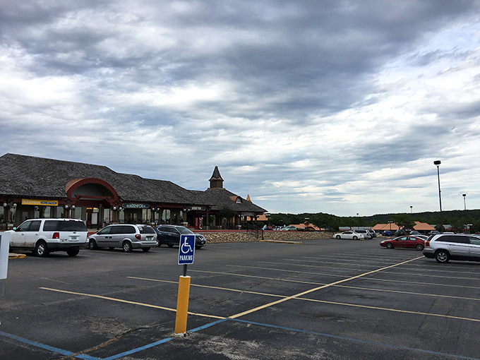 The expansive parking lot awaits under dramatic Midwest skies, ready to welcome carloads of eager shoppers to this retail playground.