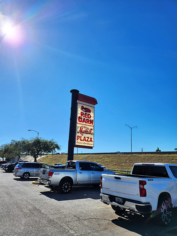 The iconic Red Barn sign stands tall against Florida's impossibly blue sky, beckoning bargain hunters and treasure seekers from miles around.