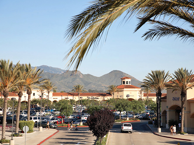 Paradise found: terracotta roofs and swaying palms frame mountain views, making even the parking lot at Camarillo Outlets Instagram-worthy.