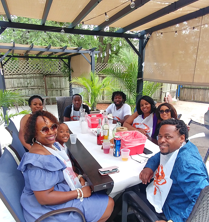 Outdoor dining where bibs become fashion statements and strangers bond over the shared experience of conquering crab legs together.