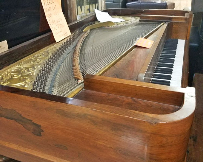A piano waiting for someone to tickle its ivories and fill a home with music again.