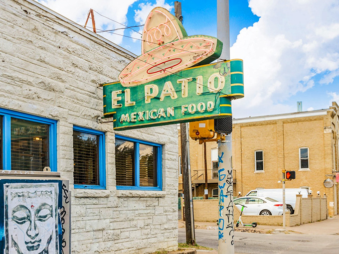 The neon sign glows against the Texas sky like a lighthouse for the hungry. El Patio isn't just a restaurant; it's an Austin institution.
