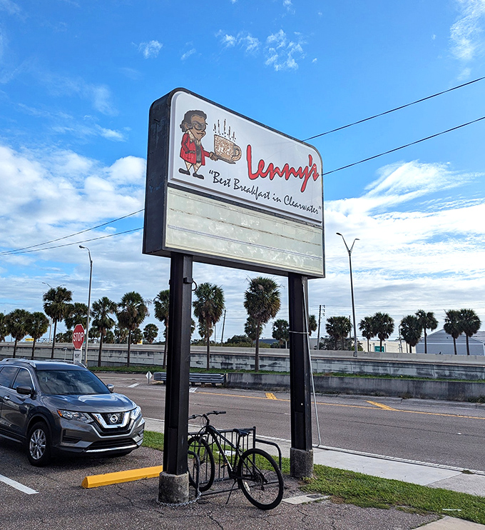 The roadside sign stands tall among palm trees, a landmark that's guided hungry travelers to breakfast bliss for generations.