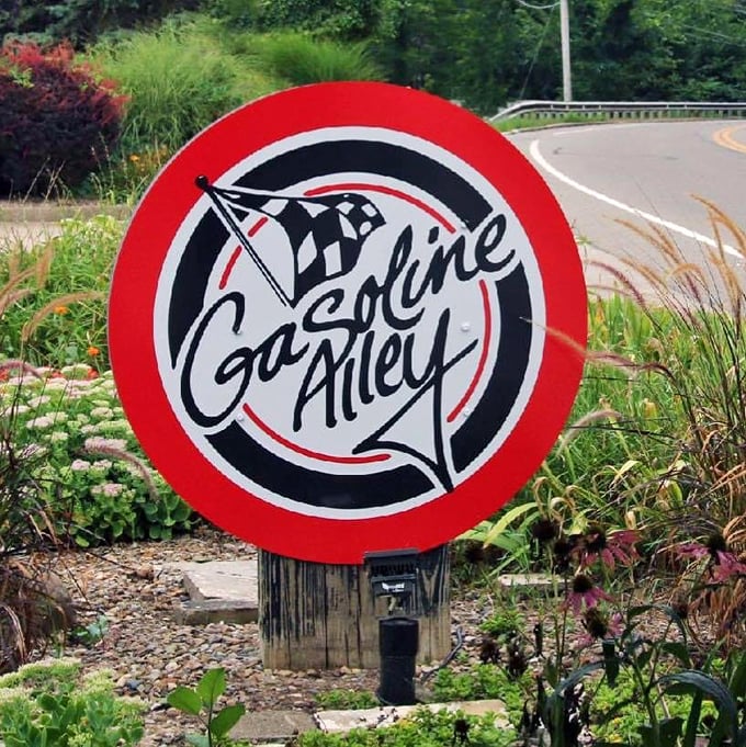 The Gasoline Alley sign stands proud among the landscaping, like a colorful sentinel announcing "Extraordinary food ahead!" The checkered flag motif promises a victory lap for your taste buds.