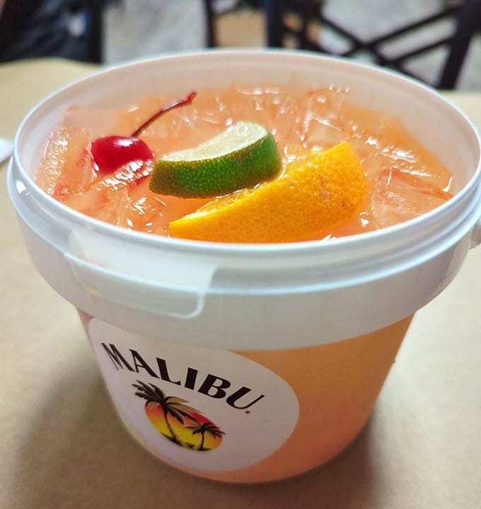 This rum bucket isn't just a drink&mdash;it's a vacation in a container, where fruit garnishes float like colorful buoys in a sea of tropical refreshment.