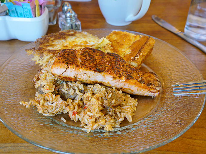 Blackened salmon resting on a bed of rice like it owns the place. The fish didn't swim upstream for nothing&mdash;it earned this delicious finale. 