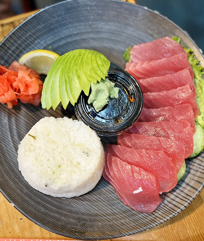 Ahi tuna sliced with surgical precision, accompanied by rice that knows its supporting role. The fish is so fresh it might still have its high school diploma.