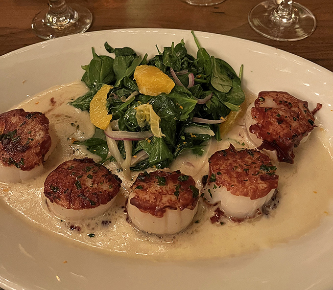These scallops aren't just perfectly seared&mdash;they're surrounded by spinach like royalty holding court in a pool of cream sauce fit for culinary nobility.