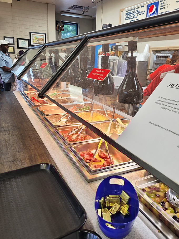 Behind the glass lies the treasure: steam tables filled with Southern classics, each waiting to be the highlight of someone's day.