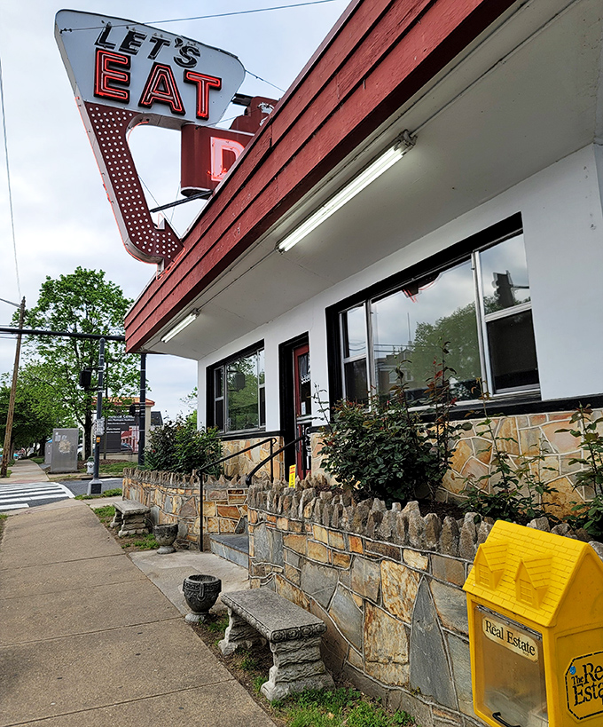 The sidewalk view showcases the diner's charming stone foundation and iconic signage. Like a lighthouse for the hungry, it guides you to safe harbor from boring breakfasts.