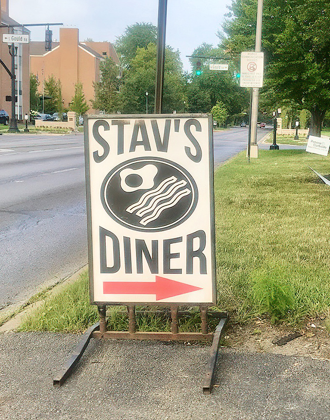 The sidewalk sign with its iconic egg and bacon logo points the way like a breakfast compass guiding hungry travelers to their destination.