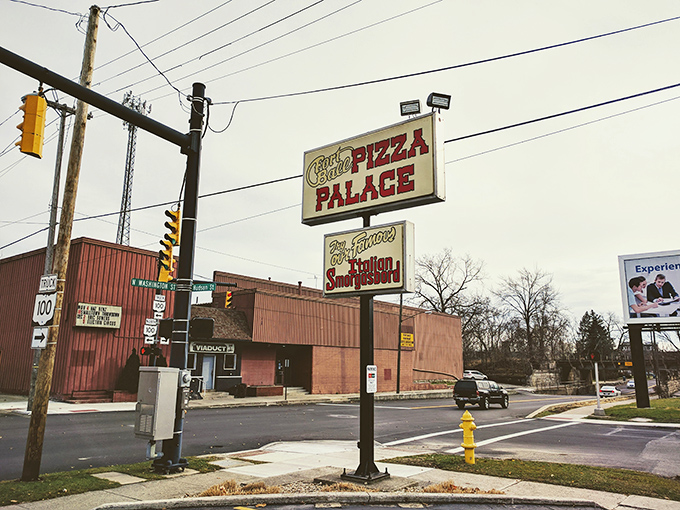 The roadside sign serves as a North Star for pizza pilgrims. Standing tall at the intersection, it's guided countless hungry travelers to their delicious destination.