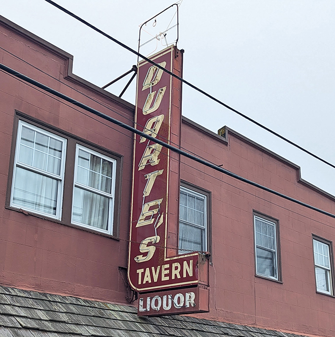That vertical neon sign has guided hungry travelers to this coastal haven for generations &ndash; a beacon of culinary promise against the foggy sky.