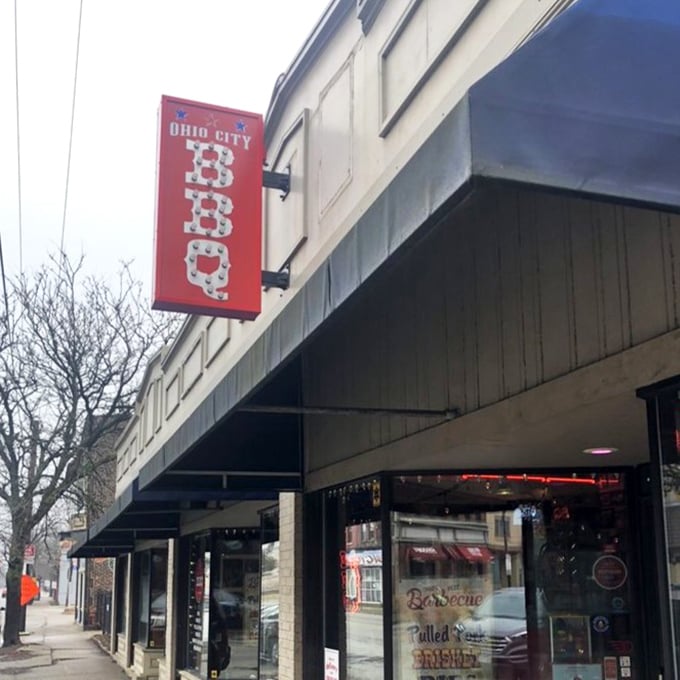 The sign beckons like a barbecue lighthouse, guiding hungry souls to a safe harbor of smoked delights in Cleveland's urban landscape.