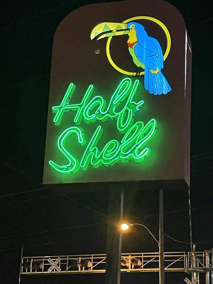 The iconic Half Shell sign featuring a tropical toucan—a whimsical beacon that promises exotic flavors in this landlocked seafood oasis.