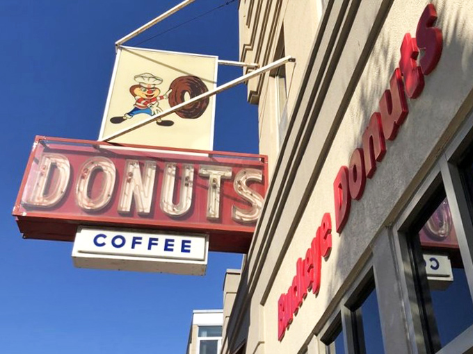 That neon sign doesn't just advertise donuts&mdash;it's a beacon of hope for the hungry, the homesick, and the hopelessly in need of sugar.
