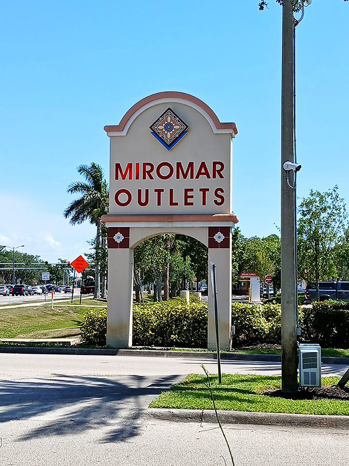 The gateway to bargain paradise stands tall under Florida's impossibly blue sky, beckoning shoppers with promises of retail adventures.
