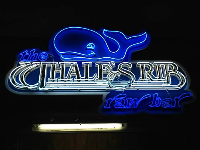 The neon whale guides hungry sailors home. At night, this blue glow has the magnetic pull of a lighthouse for those seeking seafood salvation.