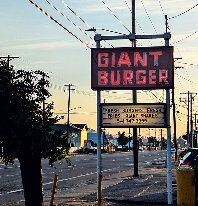 As dusk settles, the neon sign glows like a beacon for the burger-obsessed. "Fresh burgers, fresh fries, giant shakes"&mdash;a roadside haiku.
