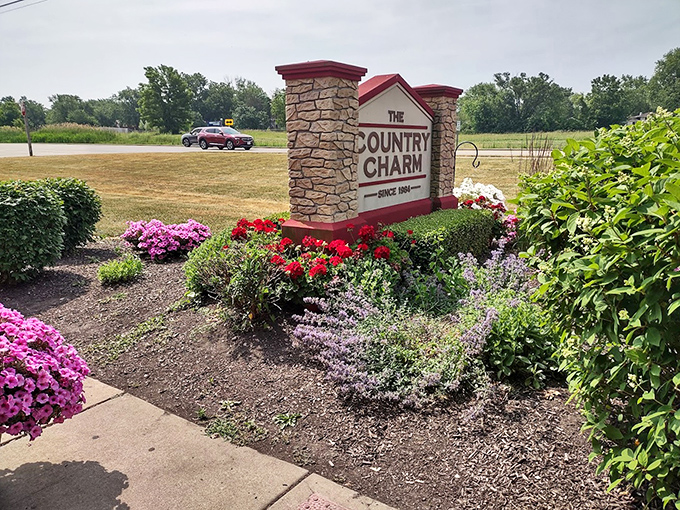 The sign stands proud, surrounded by blooms that change with the seasons. Like a culinary lighthouse guiding hungry travelers to safe, delicious harbor.