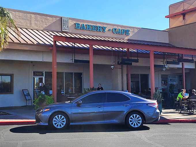 The "Bakery &bull; Cafe" sign serves as a beacon of hope for the hungry and caffeine-deprived. Like a lighthouse, but for pastry emergencies.