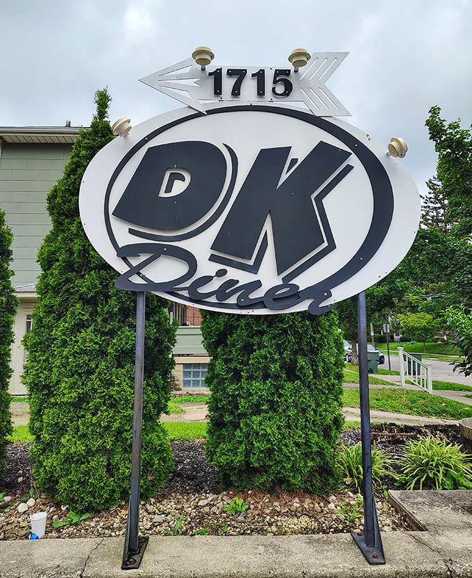 The sign stands like a retro landmark, guiding hungry pilgrims to their breakfast salvation. Follow the arrow to happiness, served all day at 1715. 