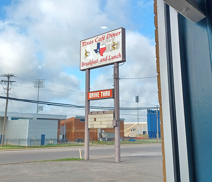 A glimpse of the sports field across the way &ndash; reminding you that you're in a true community spot where Friday night lights still matter.