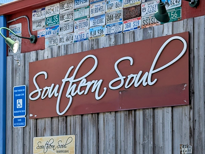 License plates above the sign tell you people come from everywhere for this barbecue. That elegant script promises food with both Southern hospitality and soul.