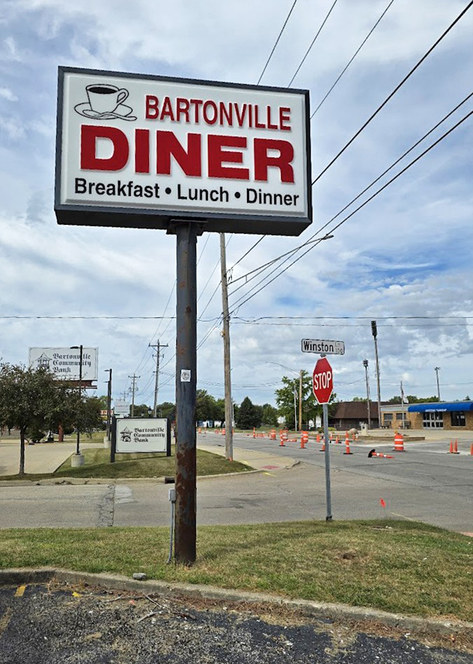 The roadside sign stands as a beacon for hungry travelers and locals alike&mdash;"Breakfast &bull; Lunch &bull; Dinner" promising satisfaction at any hour.