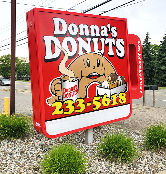 The cheerful roadside sign features their donut mascot&mdash;looking suspiciously happy for someone whose friends keep disappearing into boxes.