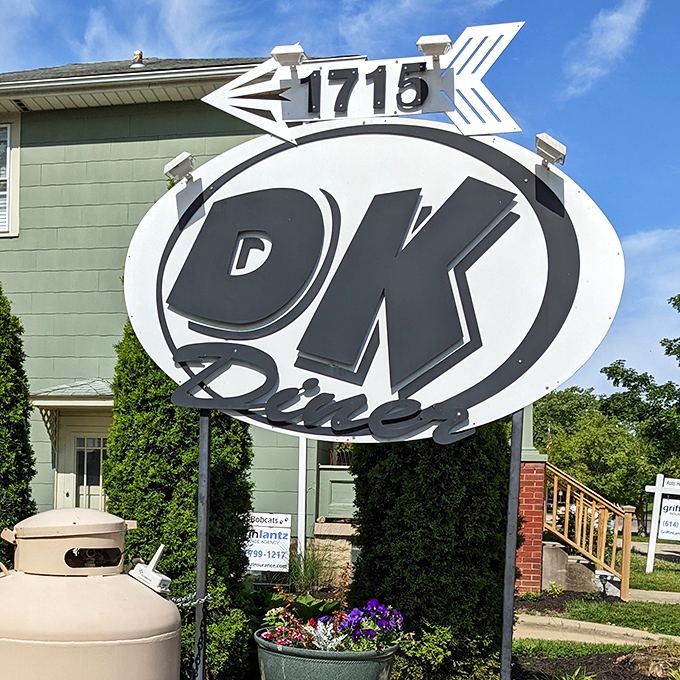 The DK Diner sign stands as a landmark for breakfast pilgrims, pointing the way to omelet nirvana like a delicious North Star.