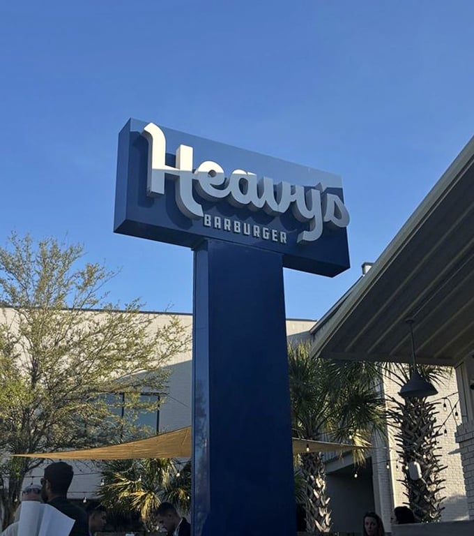 The Heavy's sign stands tall against Charleston's blue sky. Like a beacon of burger hope, it guides the hungry to their smashed-patty salvation.