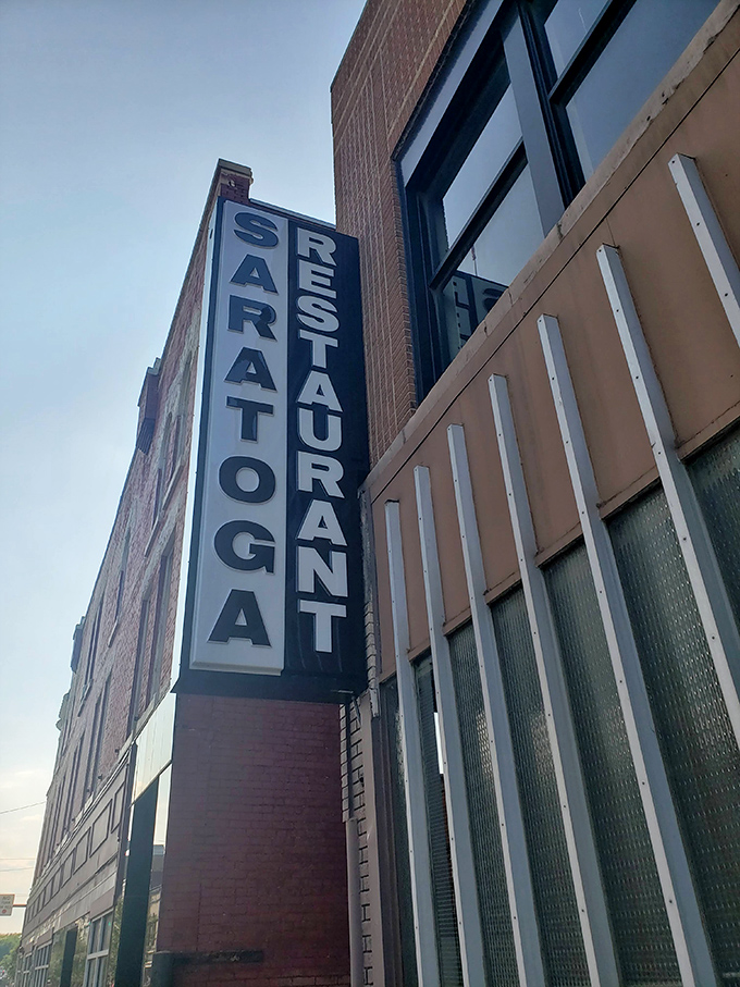 The vertical "SARATOGA RESTAURANT" sign stands like a sentinel of satisfaction, promising good food and zero pretension to all who enter.