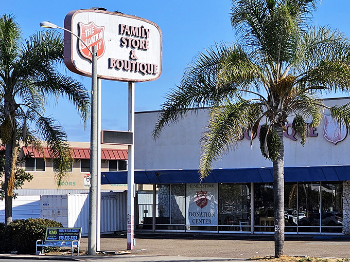 Palm trees frame the vintage signage like exclamation points, announcing this thrifting oasis to San Diego bargain hunters cruising Sports Arena Boulevard.