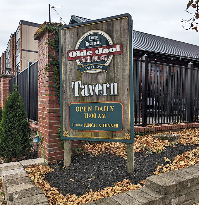 The weathered wooden sign stands sentinel, promising "Fine Cuisine" &ndash; a humble understatement for what awaits inside these brick walls.