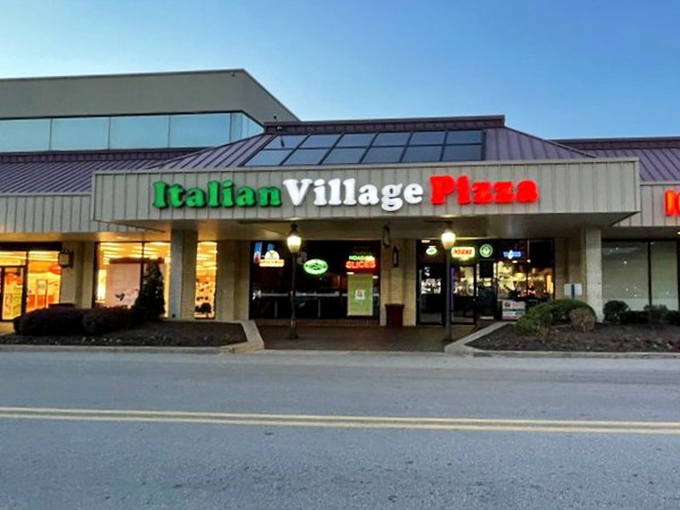 As dusk falls, the Italian Village sign glows like a beacon of hope for the hungry. Your diet can always start tomorrow.