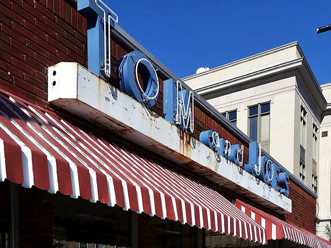 Bold yellow letters against brick announce a place where exceptional food meets unbeatable value daily.