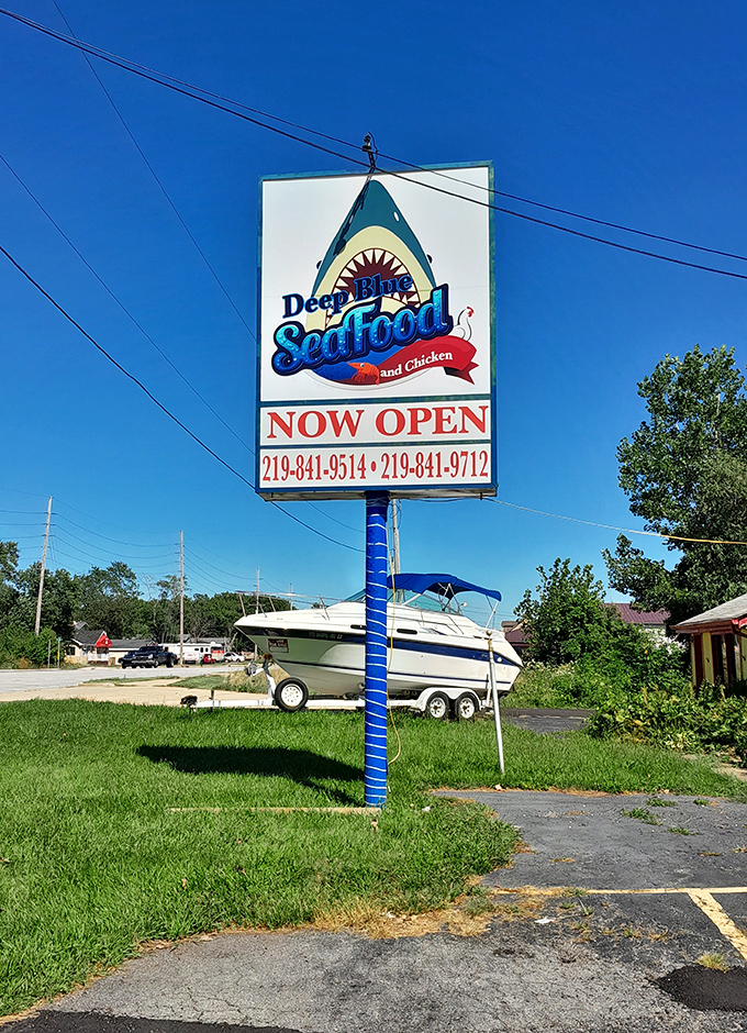 The roadside sign stands tall, a blue beacon for seafood lovers. And yes, that's a boat in the background&mdash;a fitting neighbor.