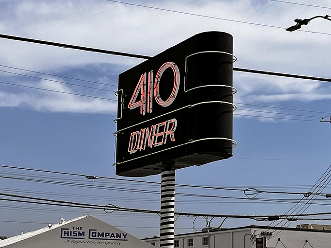That neon sign cuts through the Texas sky like a beacon, promising comfort food salvation to hungry travelers.