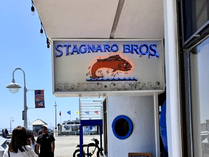 That weathered sign stands guard like a lighthouse for the hungry, beckoning seafood lovers home.