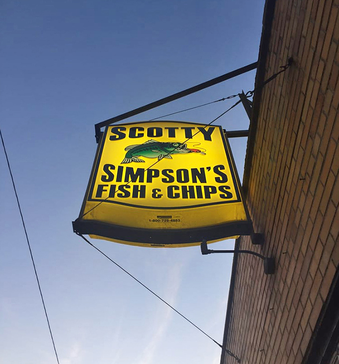 The iconic yellow sign serves as a beacon of hope for the hungry, promising golden-fried treasures within this humble brick building.