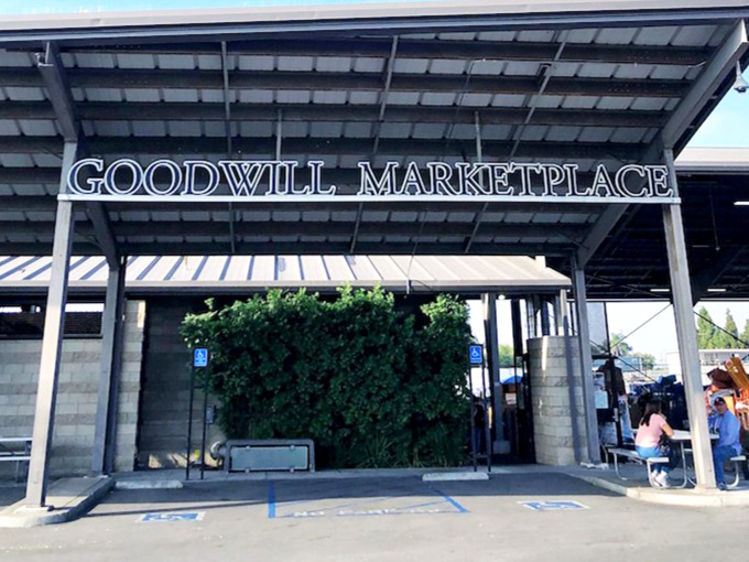 The beacon of bargain hunters everywhere, this sign promises retail therapy without the guilt. California sunshine illuminates the entrance to secondhand paradise.
